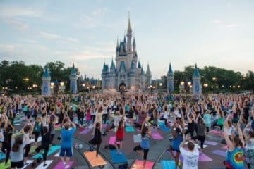 Disney cast members celebrate International Yoga Day in front of ...
