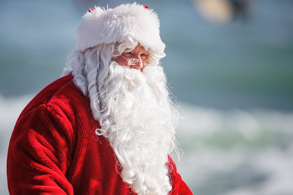 Santa swaps his sleigh for a surfboard on Florida's Space Coast
